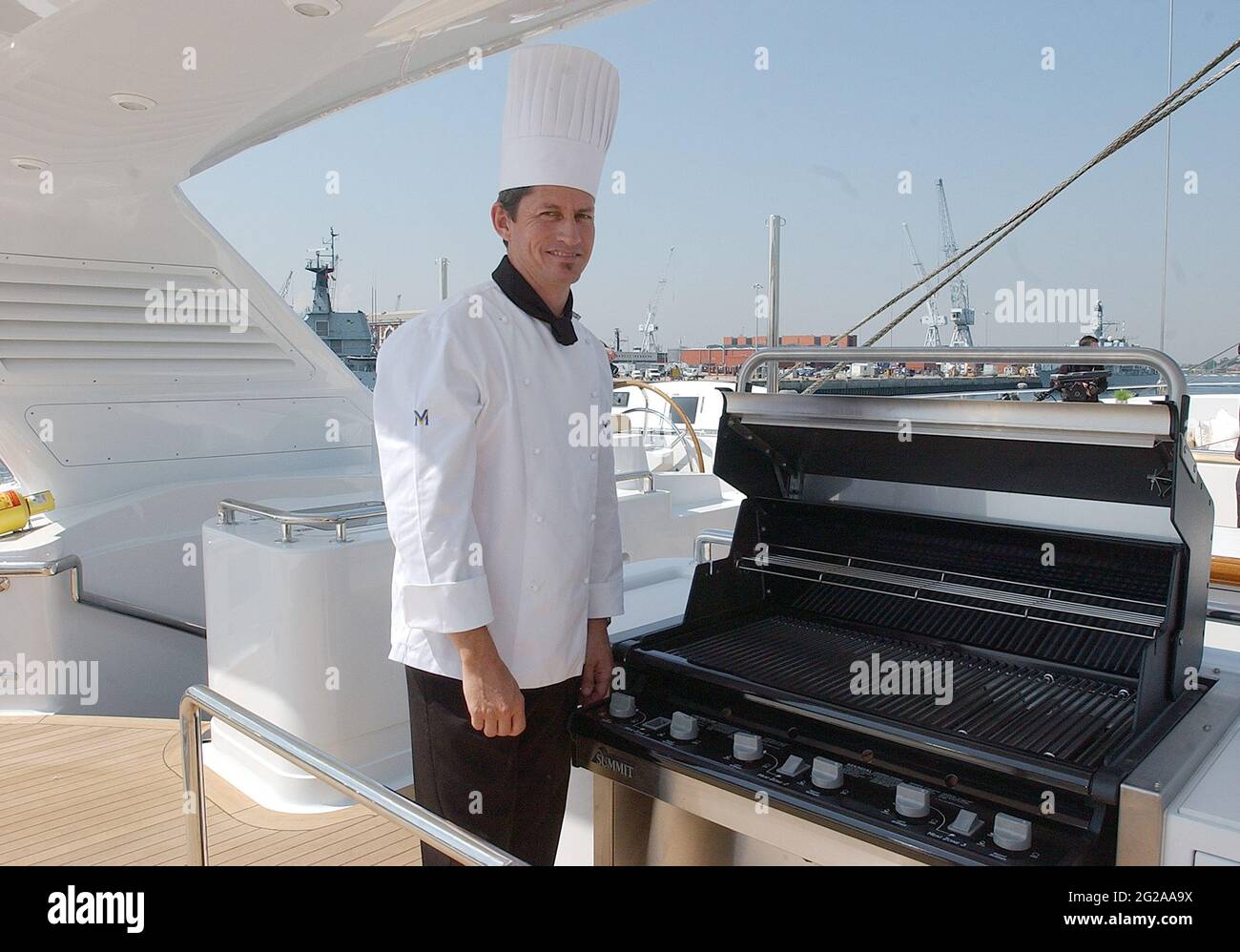 A CHEF STANDS BY AT THE BARBECUE ABOARD MIRABELLA V THE WORLD LARGEST ...