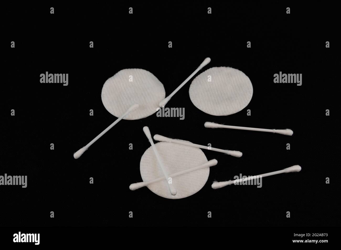 Cotton pads and ear sticks isolated on a black background Stock Photo ...