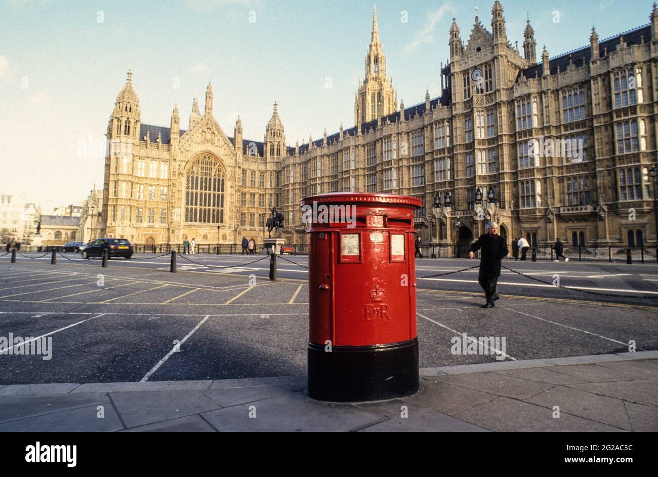 Ever present Royal Mail: a classic red letterbox in front of the Houses ...