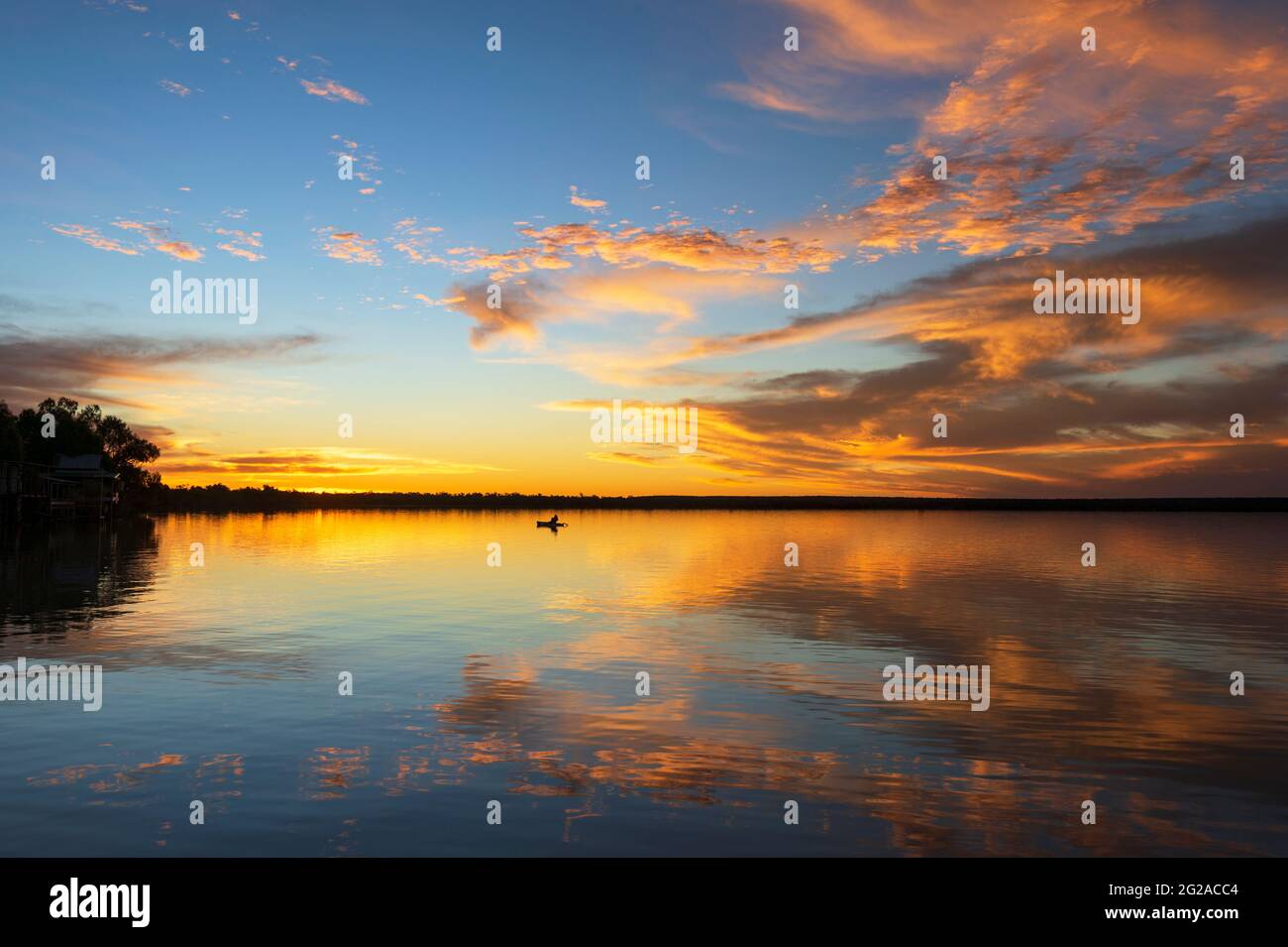 Silhouette of a kayak at sunset on Lake Dunn, a popular tourist ...