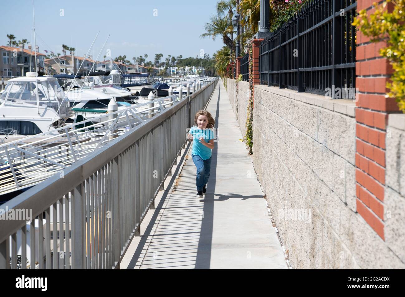 Active boy kid enjoy summer holidays running on promenade, fun Stock ...