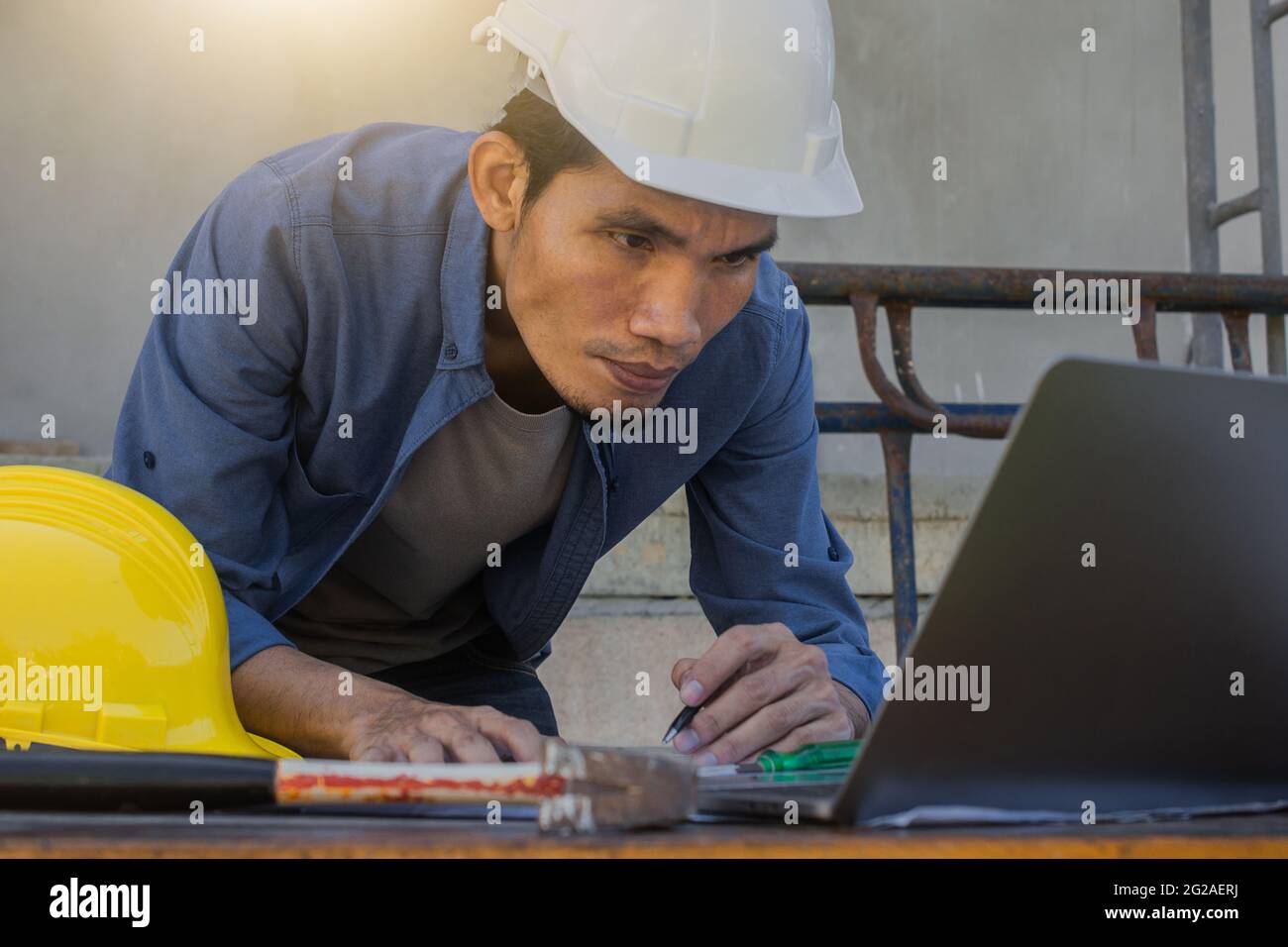 Worker employee working by computer technology on site construction ...