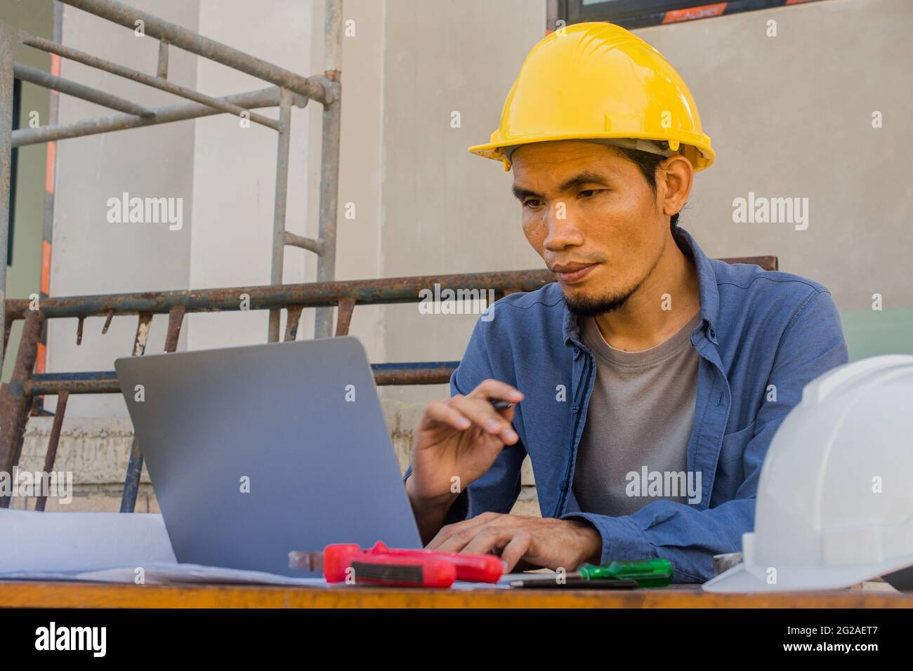 Worker employee working by computer technology on site construction ...