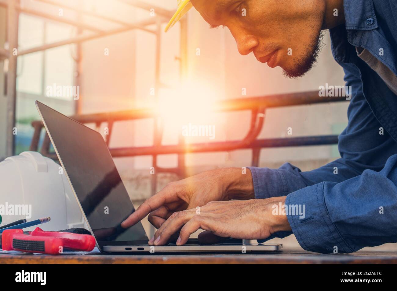 Worker employee working by computer technology on site construction ...