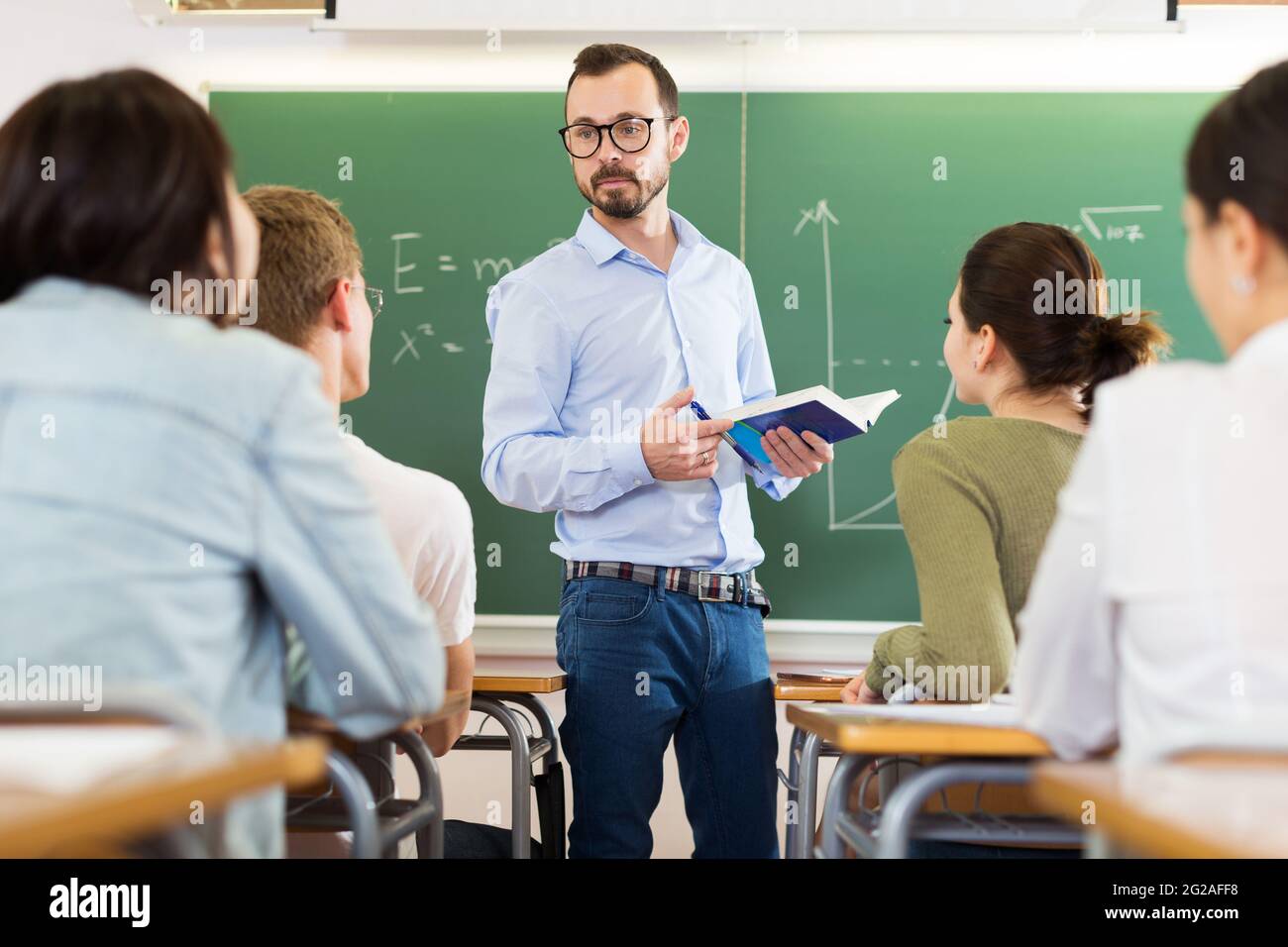 Teacher is giving lecture for students Stock Photo - Alamy