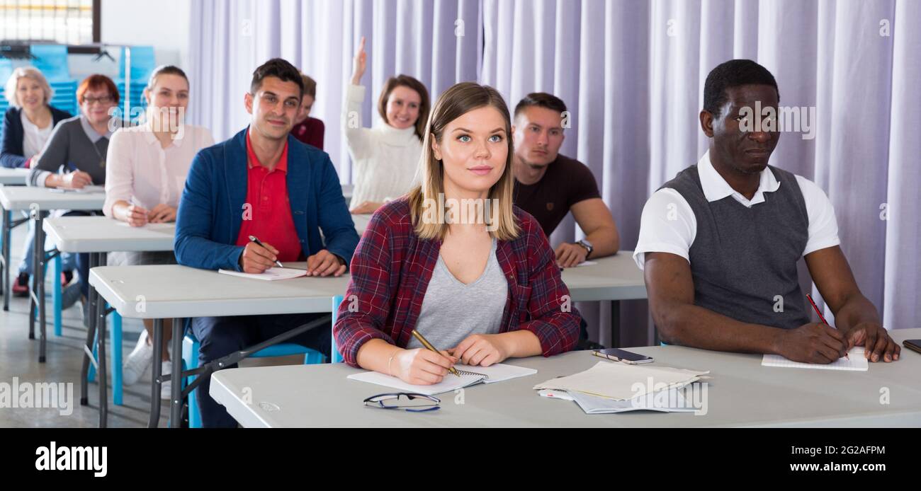 Adult students listening in classroom Stock Photo - Alamy