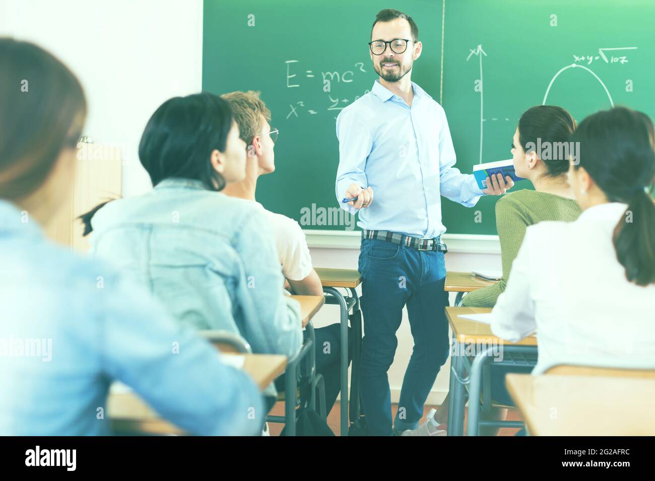 Male teacher giving lecture for students Stock Photo - Alamy