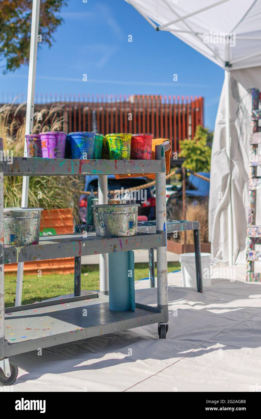 An artist colorful paint buckets on a cart Stock Photo - Alamy