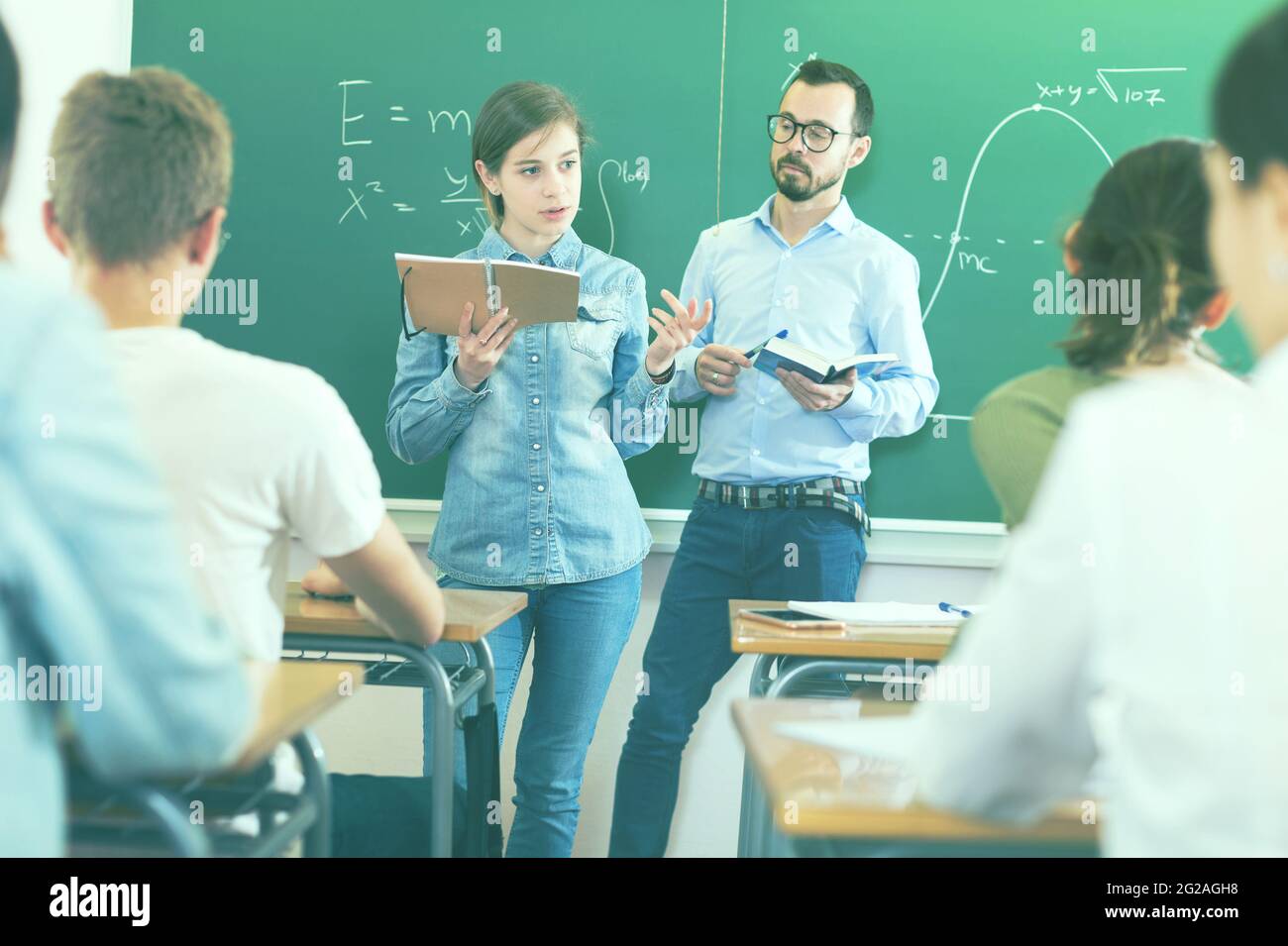 schoolgirl answer about task in the classroom Stock Photo - Alamy