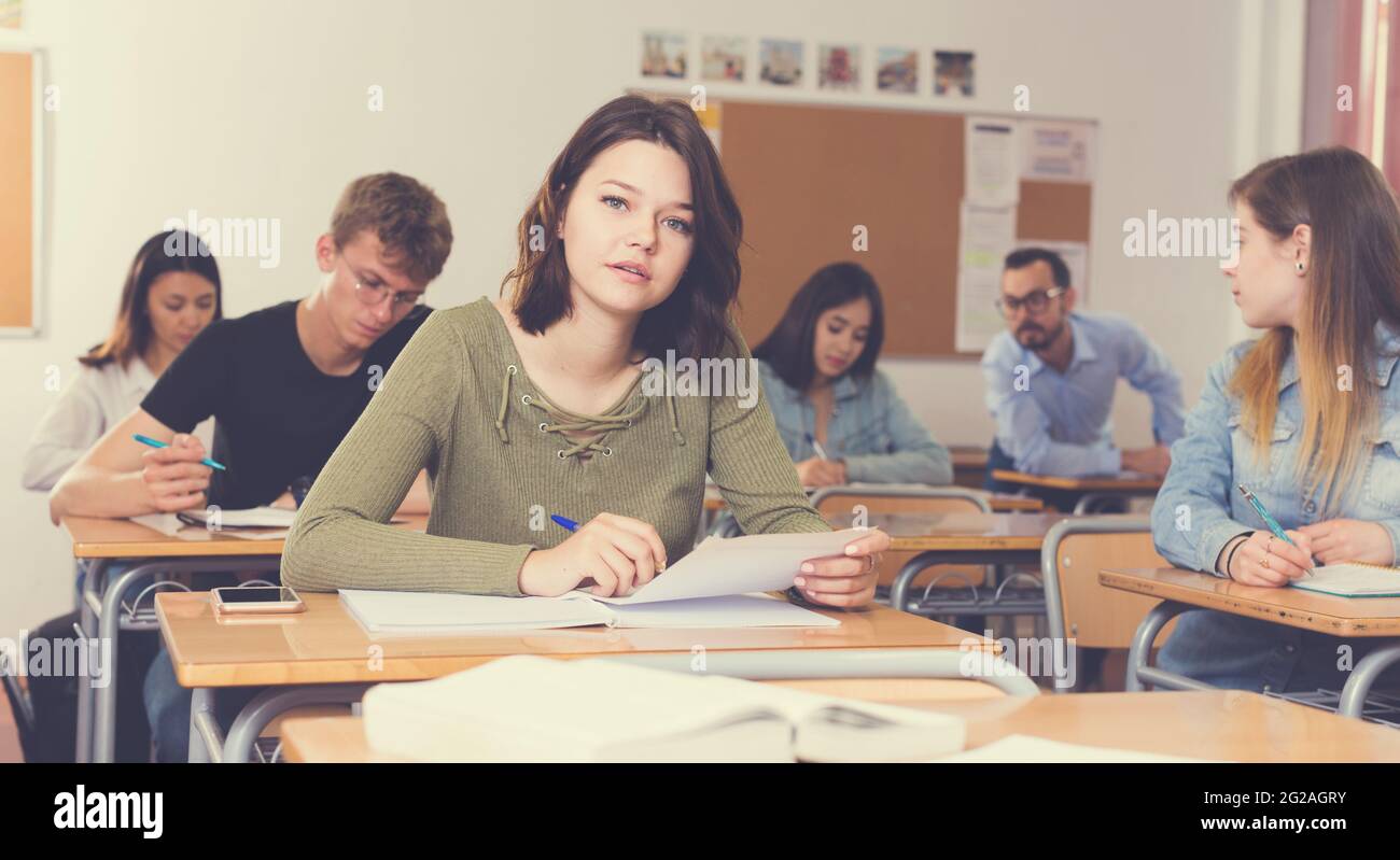 Girl is writing test and answer about task Stock Photo - Alamy