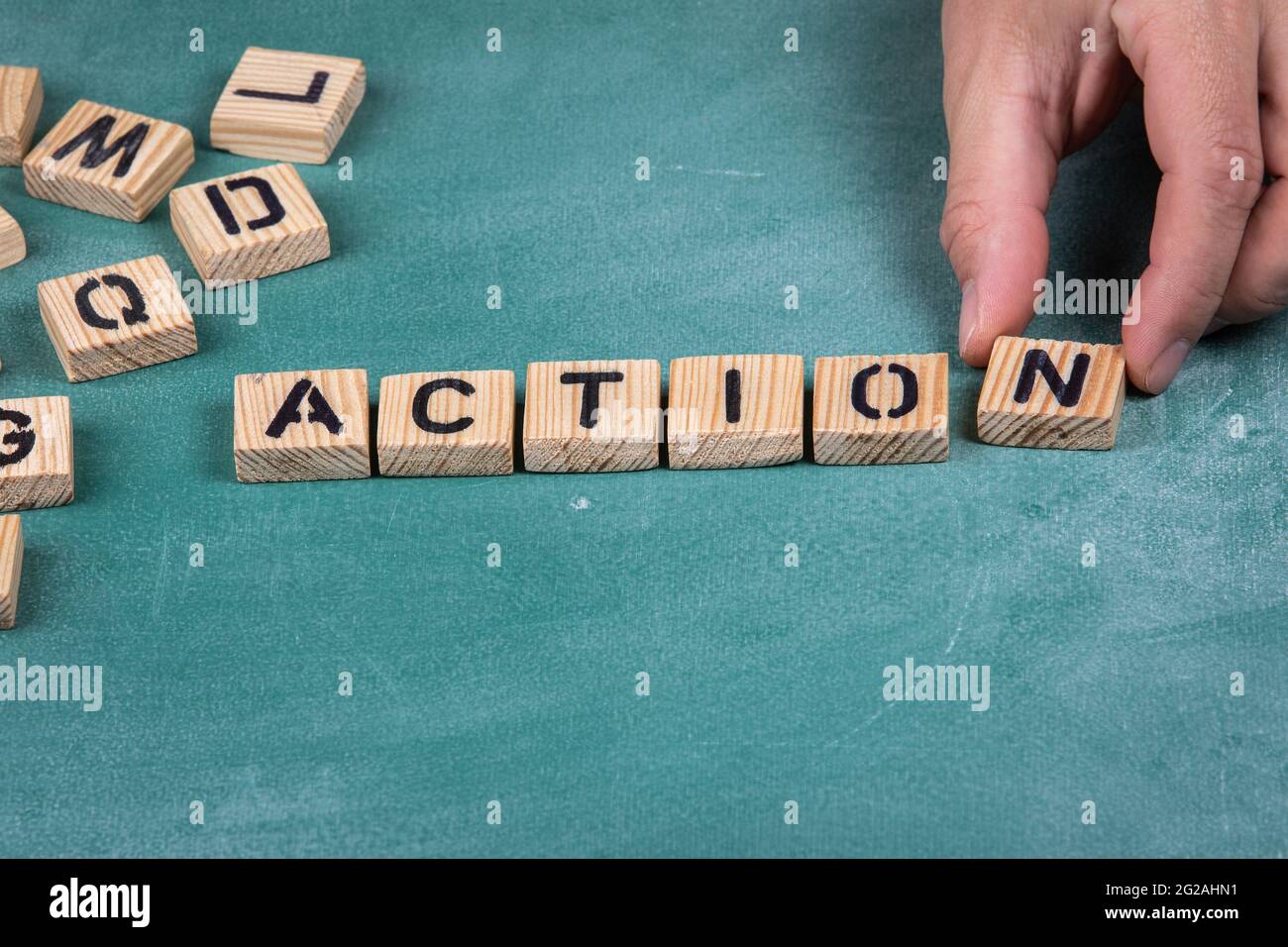 Action. Wooden alphabet letters on a green blackboard background Stock ...