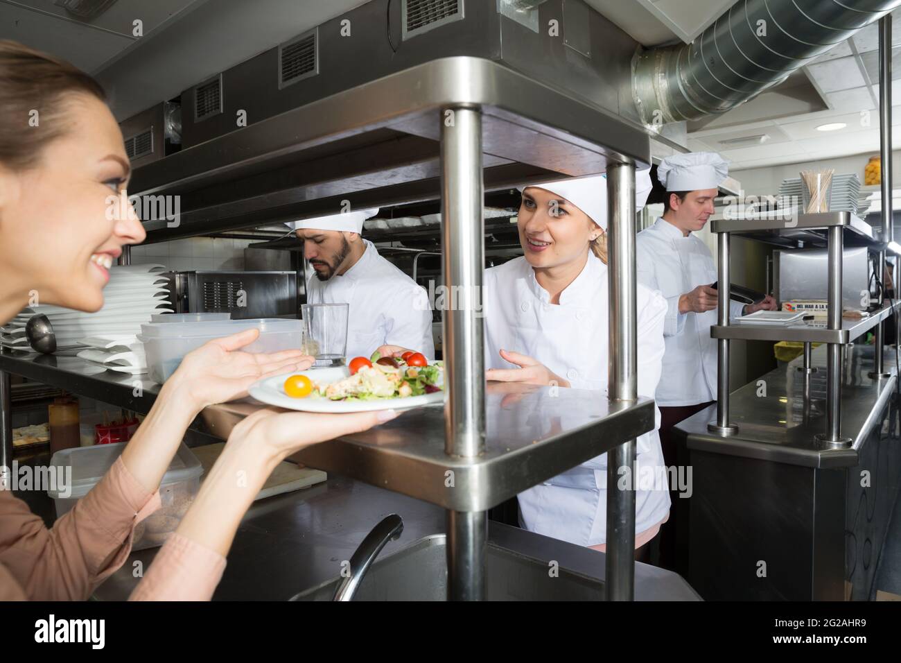 Head chef checking dishes in kitchen Stock Photo - Alamy