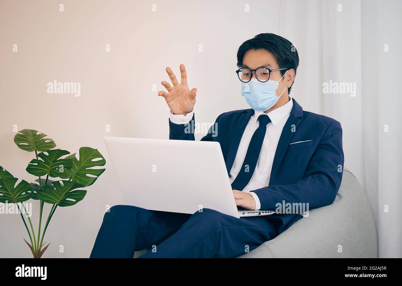 Asian Financial Advisor Wear Face Mask and Glasses Video Conference in ...
