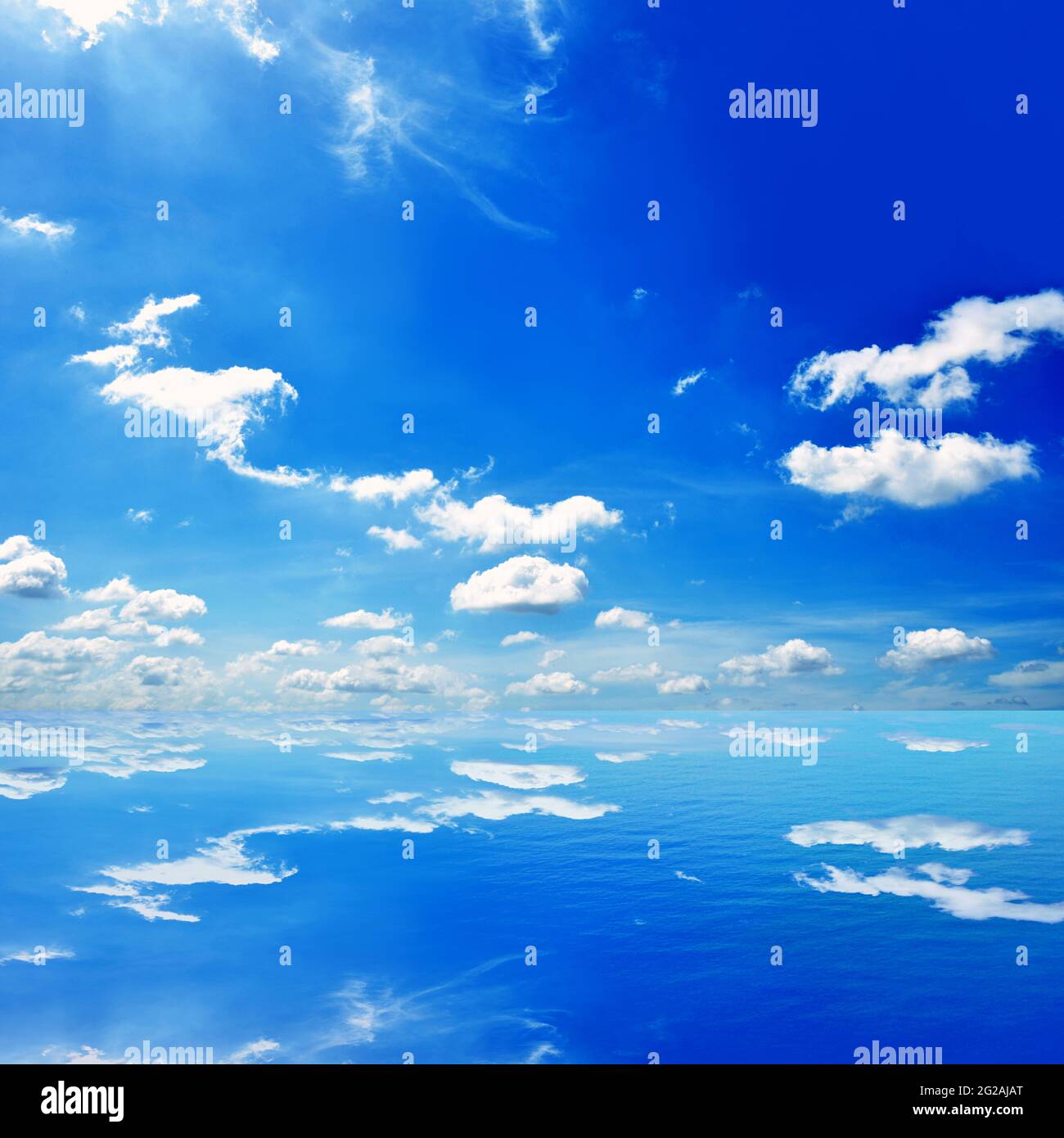 Clouds and blue sky with reflection on the sea Stock Photo - Alamy