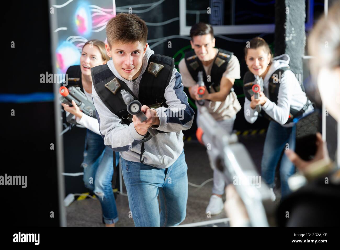 Excited guy laser tag player in bright beams Stock Photo - Alamy