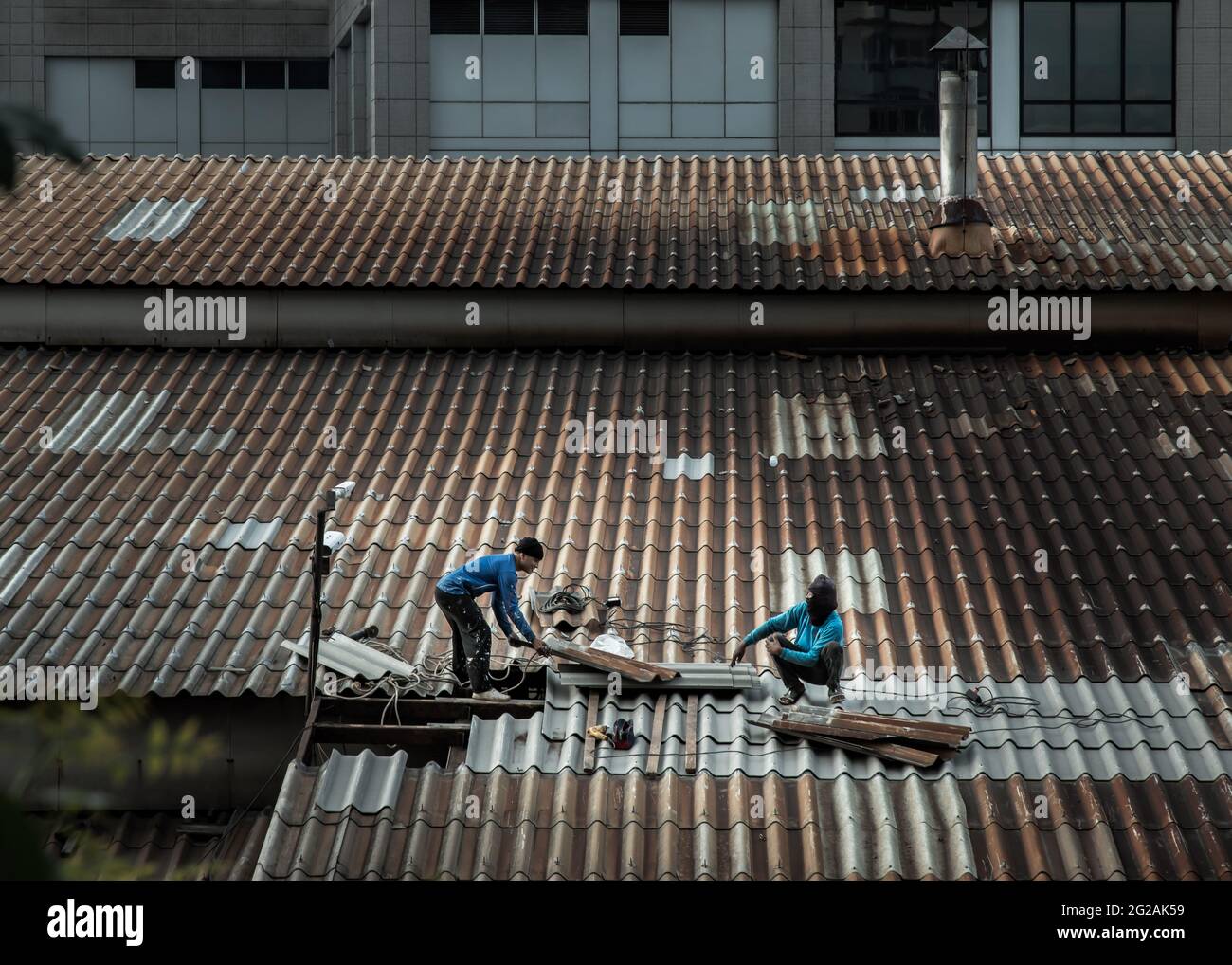 Bangkok, Thailand - 28 May 2021 : Two handyman workers repairing tiles ...