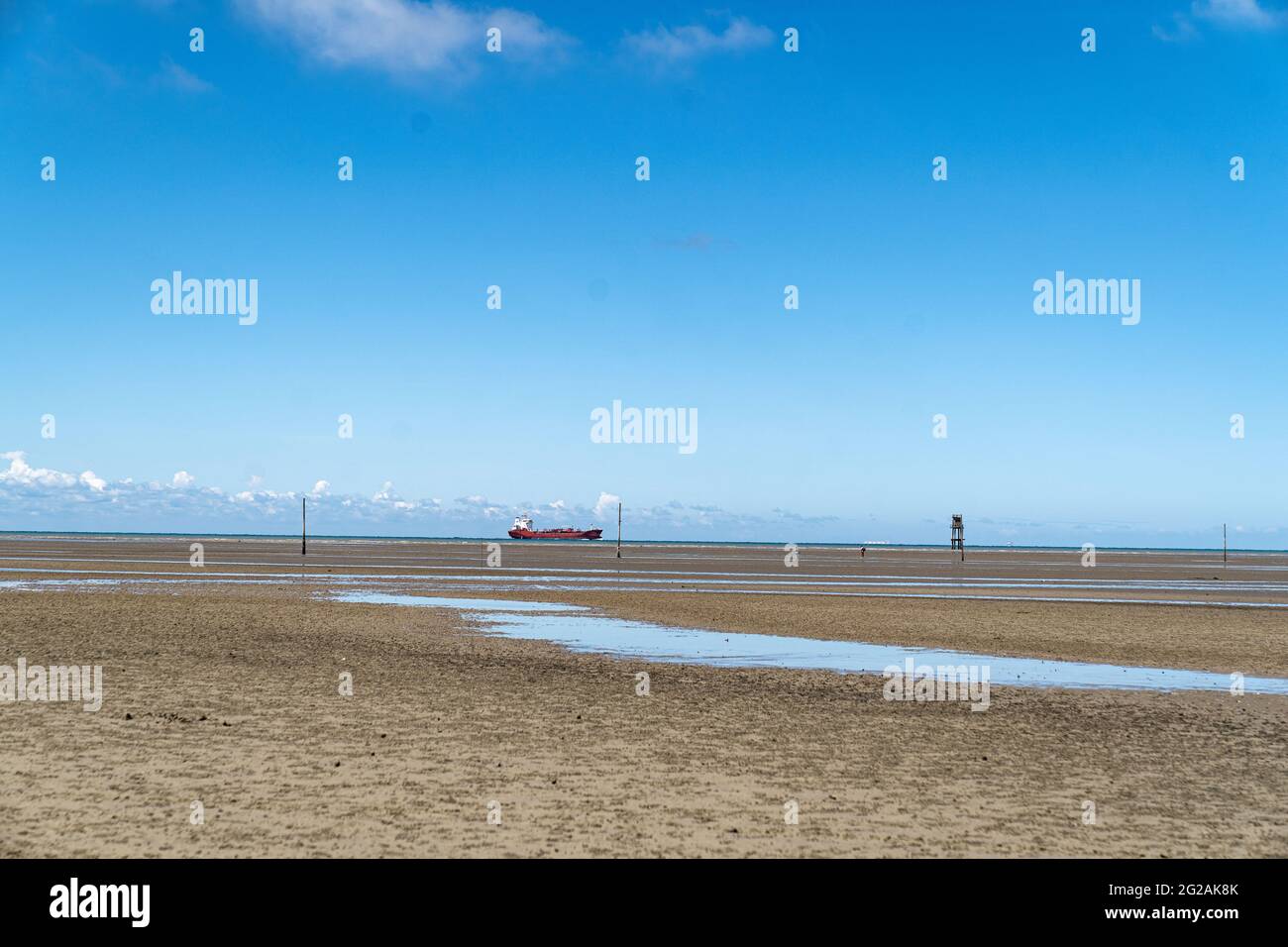 Blue sky and beautiful beach with low tide in Asia, a ship in the ...