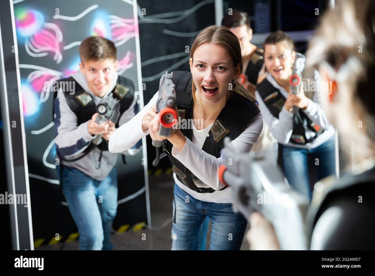 Smiling girl with laser guns took aim and having fun with friends Stock ...
