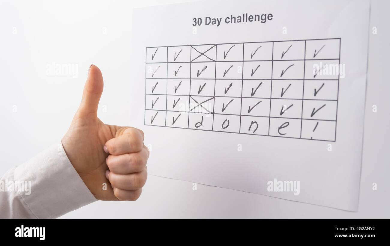 Cropped view of woman completing 30 days of challenge and showing thumb ...