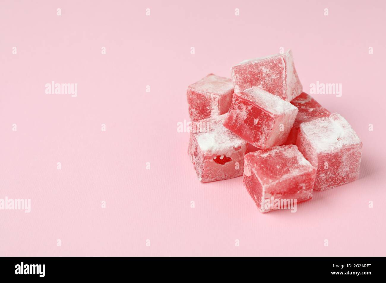 Delicious turkish delight cubes on pink background Stock Photo - Alamy
