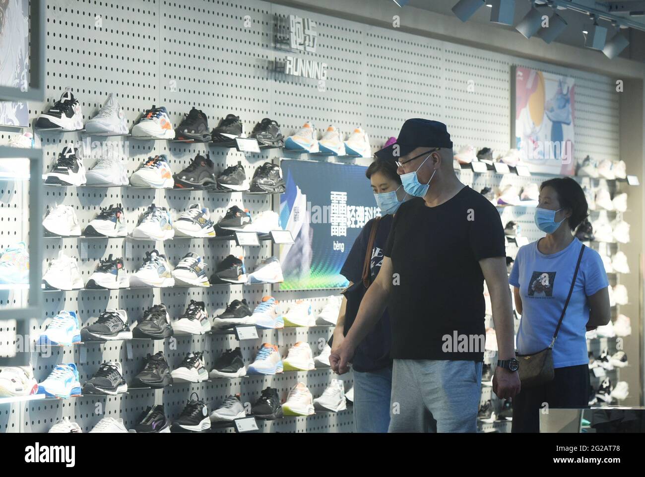 HANGZHOU, CHINA - JUNE 10, 2021 - Customers choose clothes and other ...