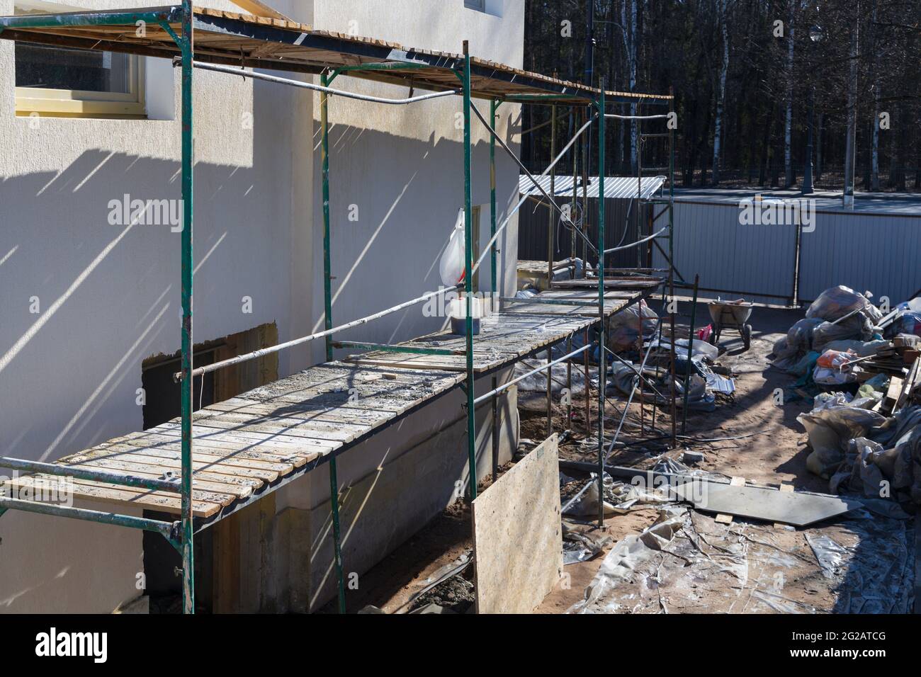Scaffolding and a courtyard with a pile of construction debris during ...
