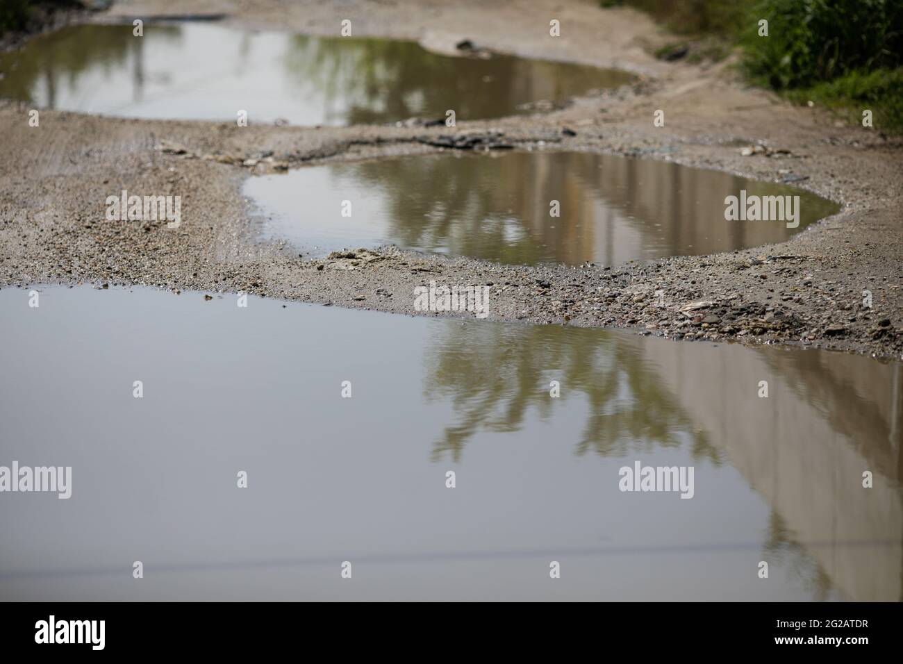 Pothole filled with rainwater hi-res stock photography and images - Alamy