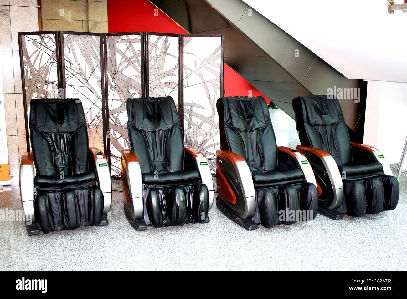 four electric massager chairs for customers Stock Photo - Alamy