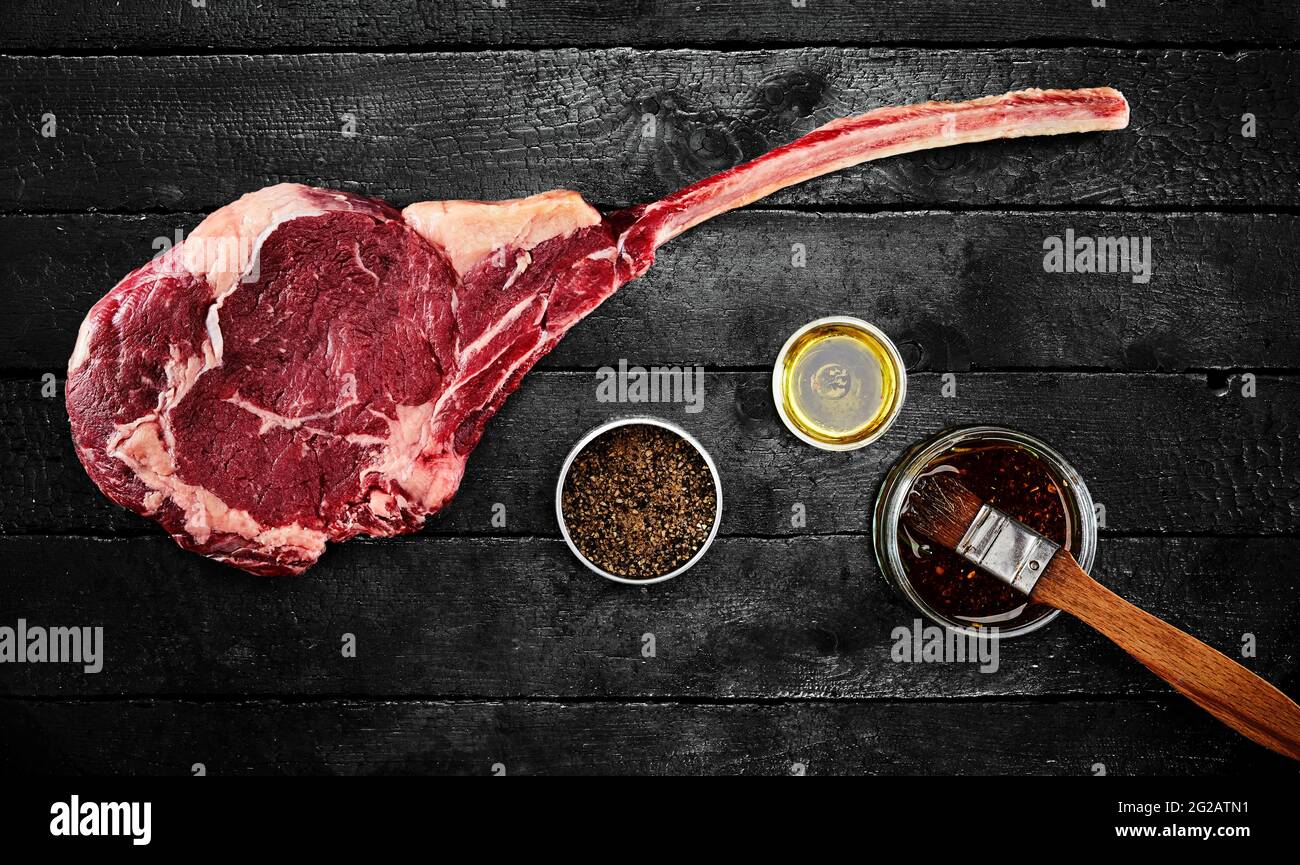 From above of raw fresh rack of lamb arranged on dark table with olive ...