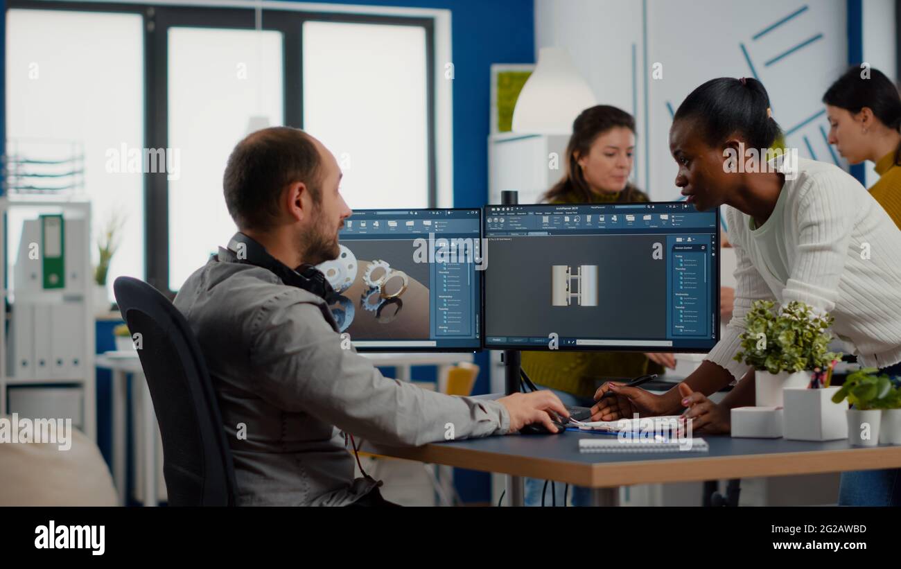 Black employee and project manager analysing mechanical metalic parts ...