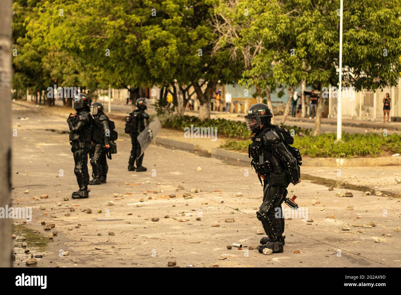 A colombian riot police officer (ESMAD) gestures to demonstrators ...