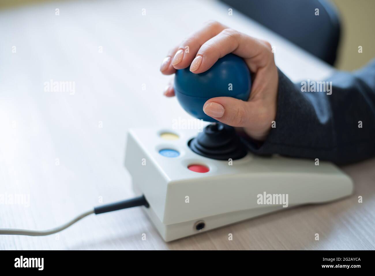 Woman with cerebral palsy works on a specialized computer mouse Stock ...