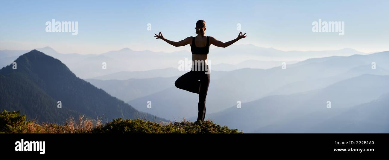 Back view of young woman doing meditation on fresh air. Concept of ...