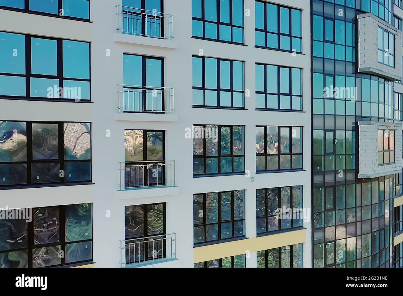 Many windows on new apartment building facade under construction. Real ...