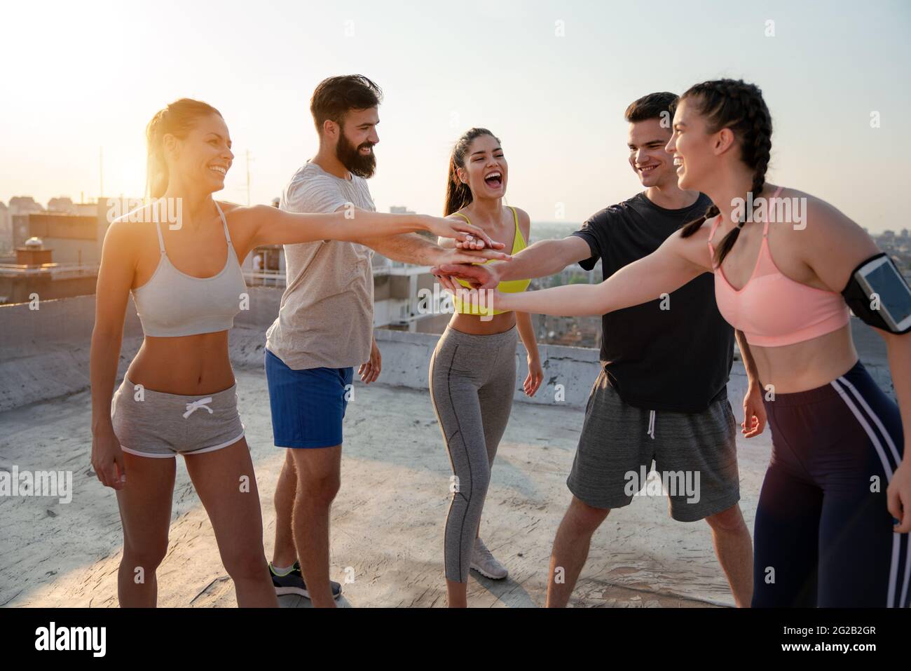 Group of fit healthy friends, people exercising together outdoor Stock ...