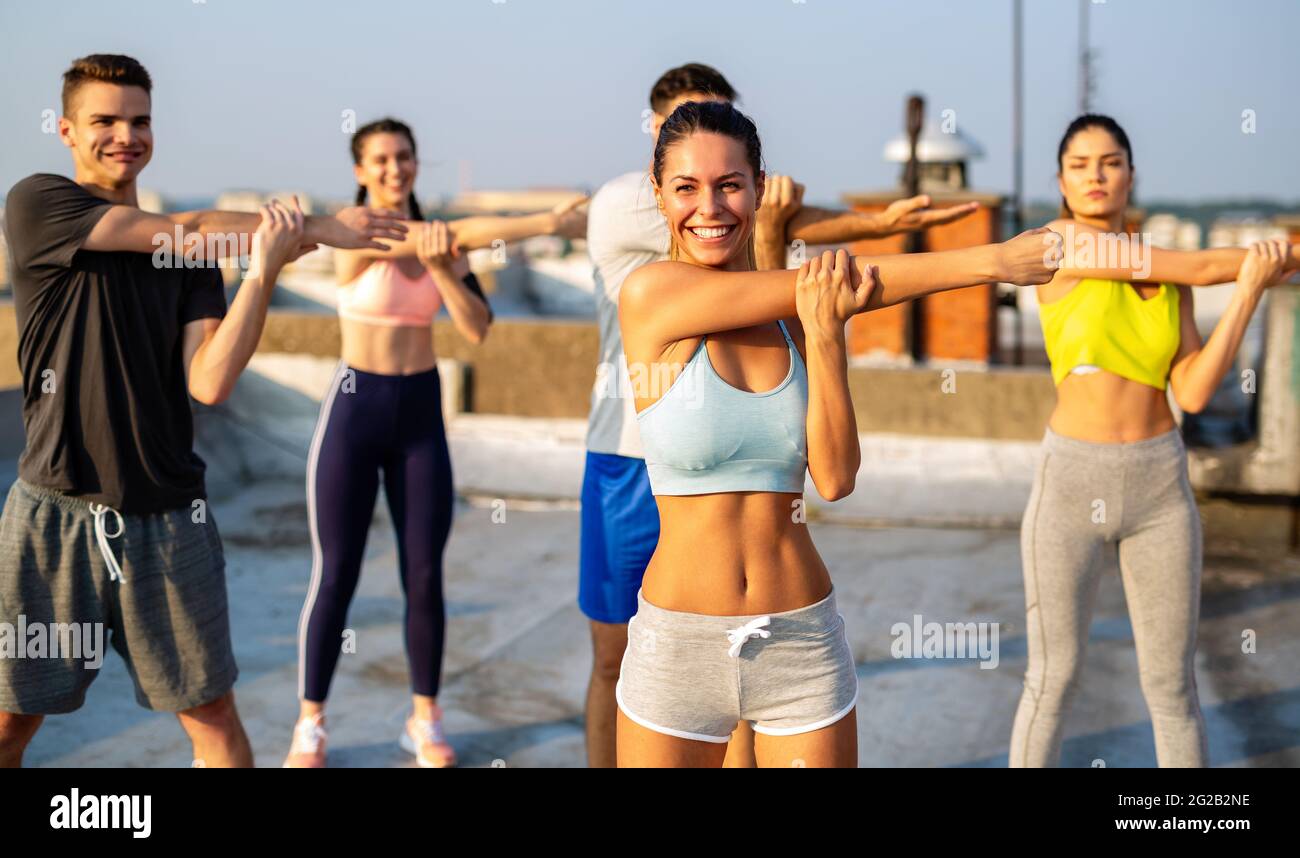 Group of fit healthy friend, people exercising together outdoor Stock ...