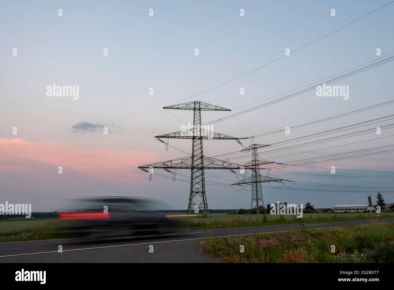 Electricity pylons along a road hi-res stock photography and images - Alamy