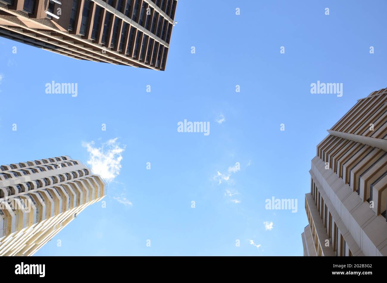 Buildings in blue sky background - looking up angle Stock Photo - Alamy