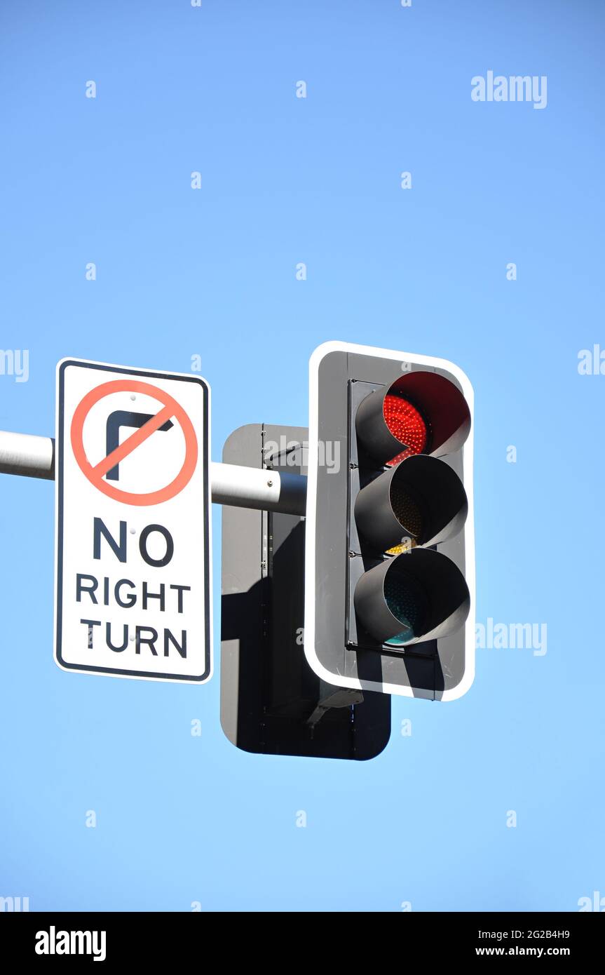 Traffic light and NO RIGHT TURN sign on blue sky background Stock Photo ...