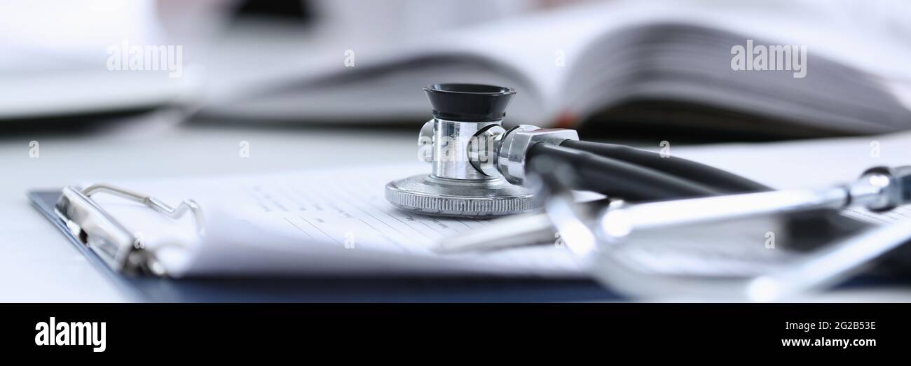 Stethoscope head lying on medical forms closeup Stock Photo - Alamy
