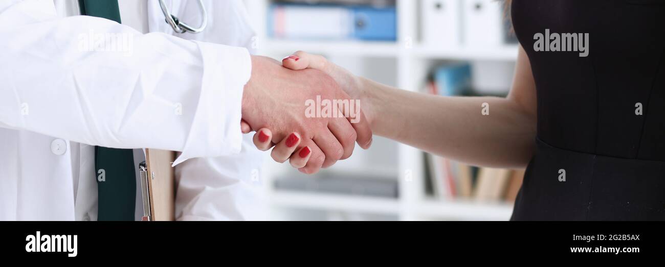Doctor shake hand as hello with patient in office closeup Stock Photo ...
