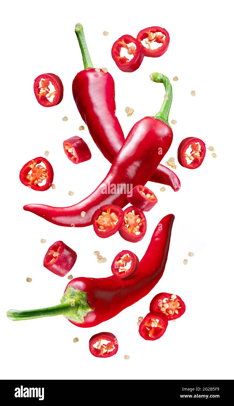 Fresh red chilli peppers and cross sections of chilli pepper with seeds ...