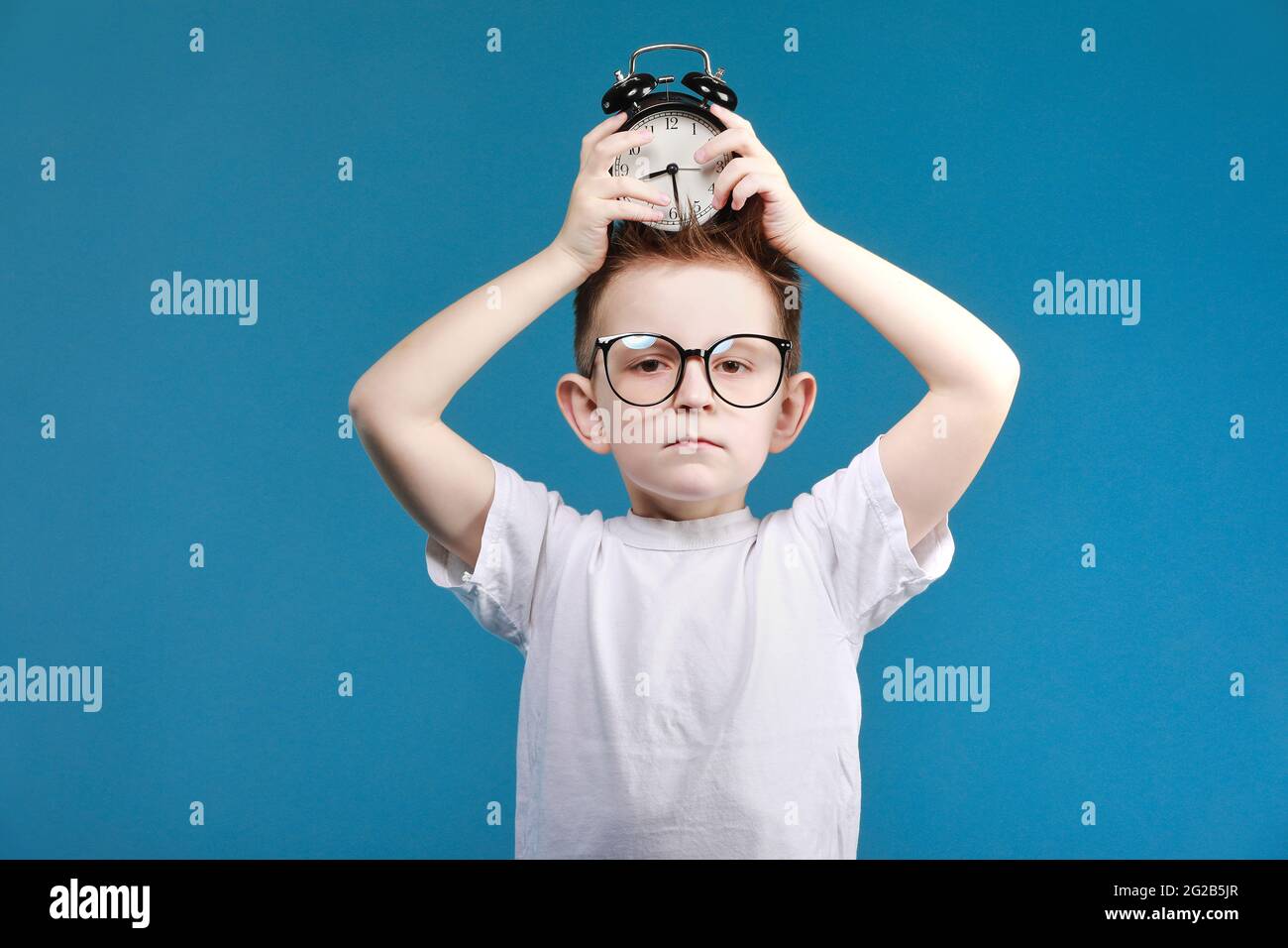 Time management. Morning. little boy with alarm clock. Happy childhood ...
