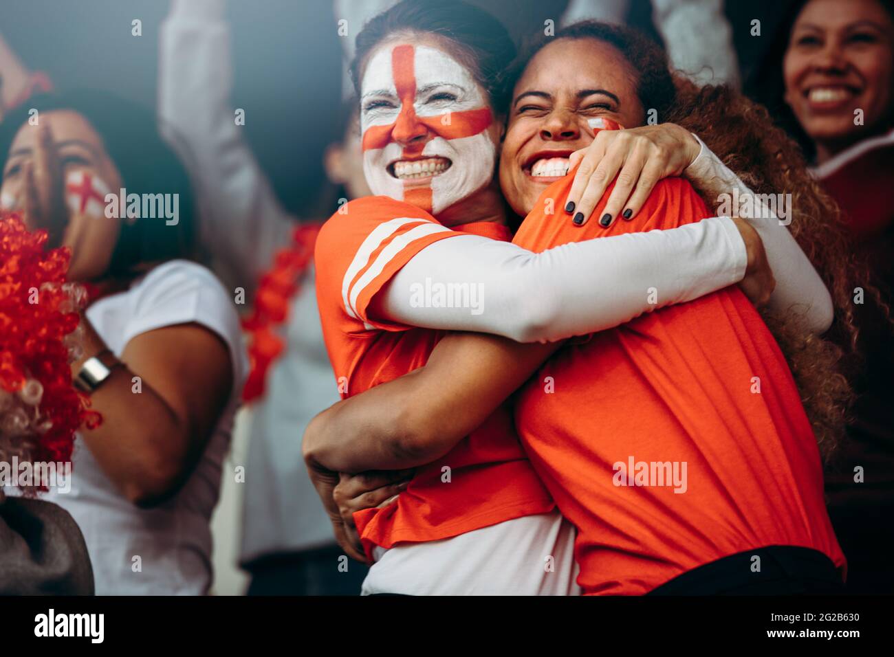 Female soccer fans of England hugging and celebrating after their team ...