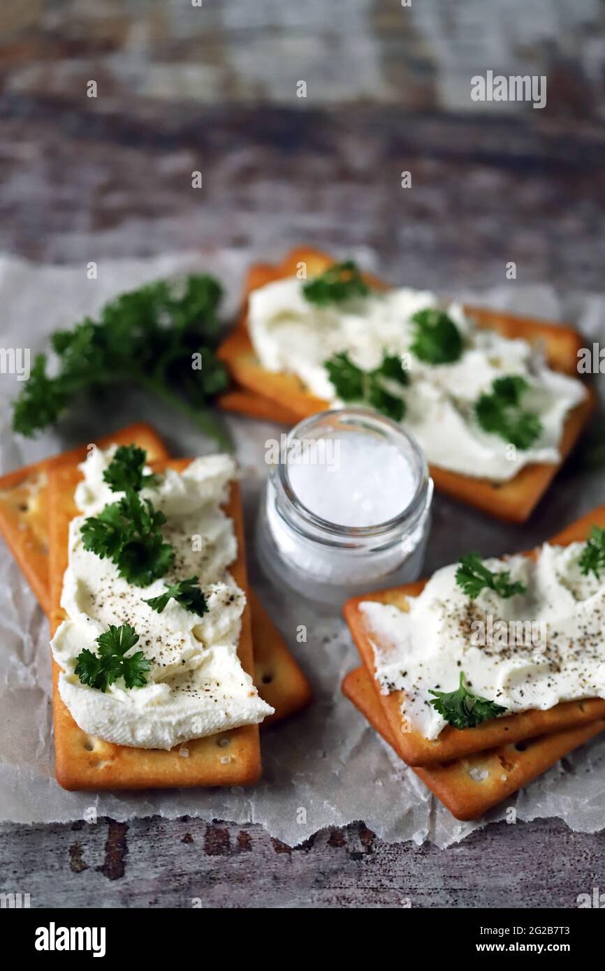 Cream cheese crackers and herbs. Healthy snack Stock Photo - Alamy