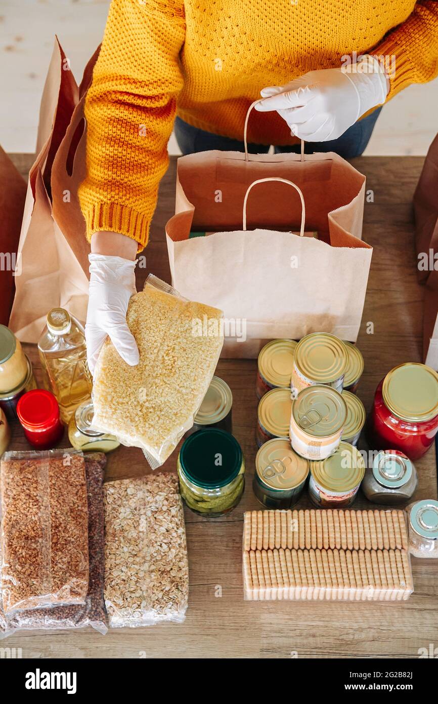 Hands in gloves packing hi-res stock photography and images - Alamy