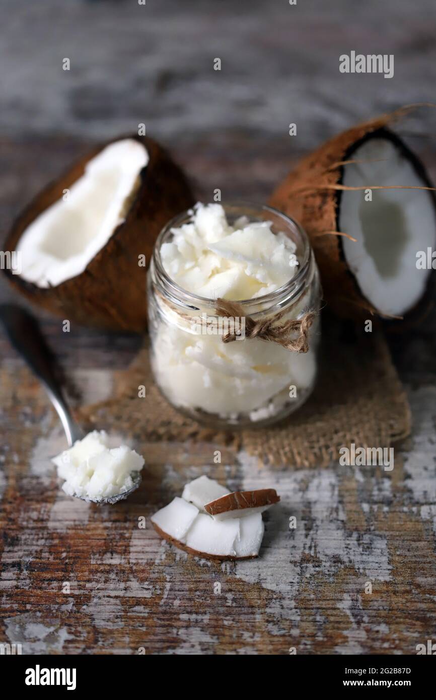 Coconut oil in a jar. Coconut halves Stock Photo - Alamy