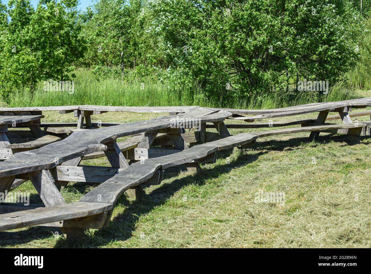 Large picnic table and bench in a sunny public park Stock Photo - Alamy