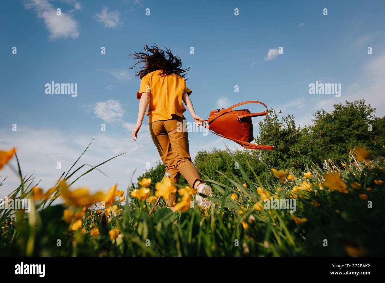 Woman running through flowers hi-res stock photography and images - Alamy