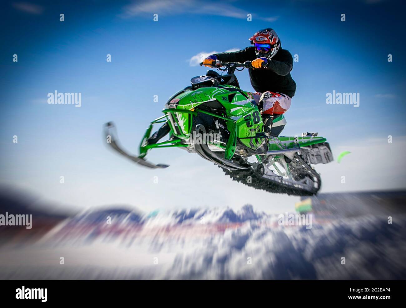 snowmobile rider jumping through snow. Close up Stock Photo - Alamy